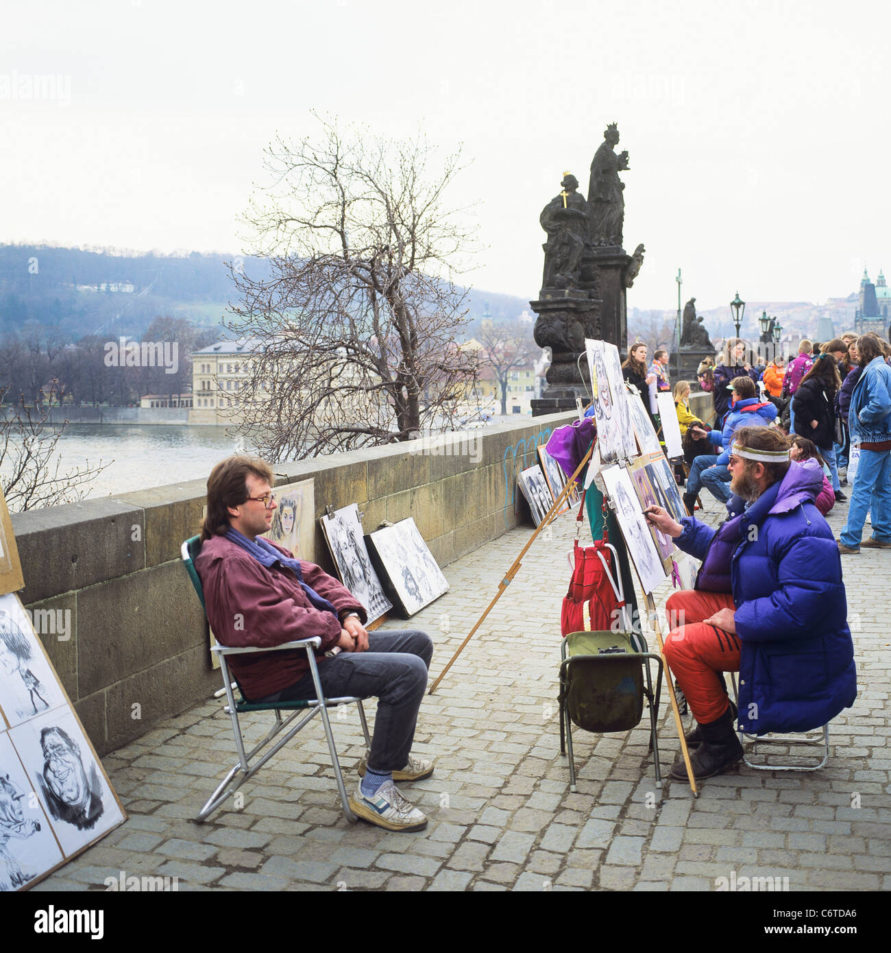Street artists sketching tourist portraits, Charles bridge, Prague ...