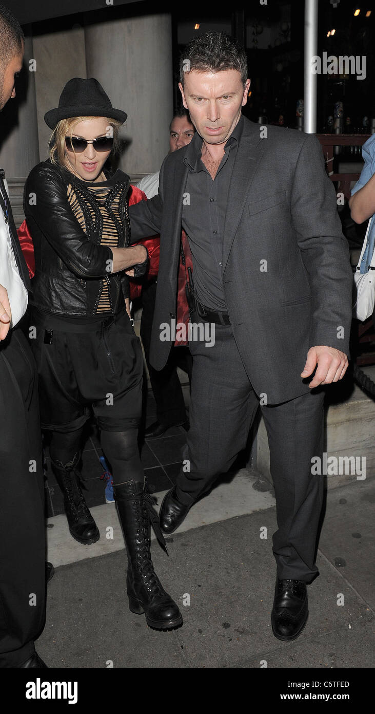 Madonna is escorted out of Aura nightclub by her personal bodyguard ...