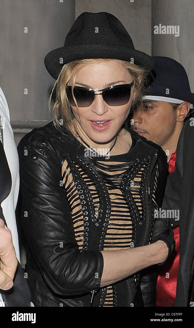 Madonna is escorted out of Aura nightclub by her personal bodyguard ...