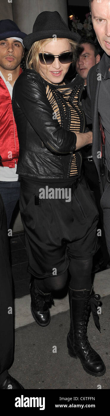 Madonna is escorted out of Aura nightclub by her personal bodyguard ...