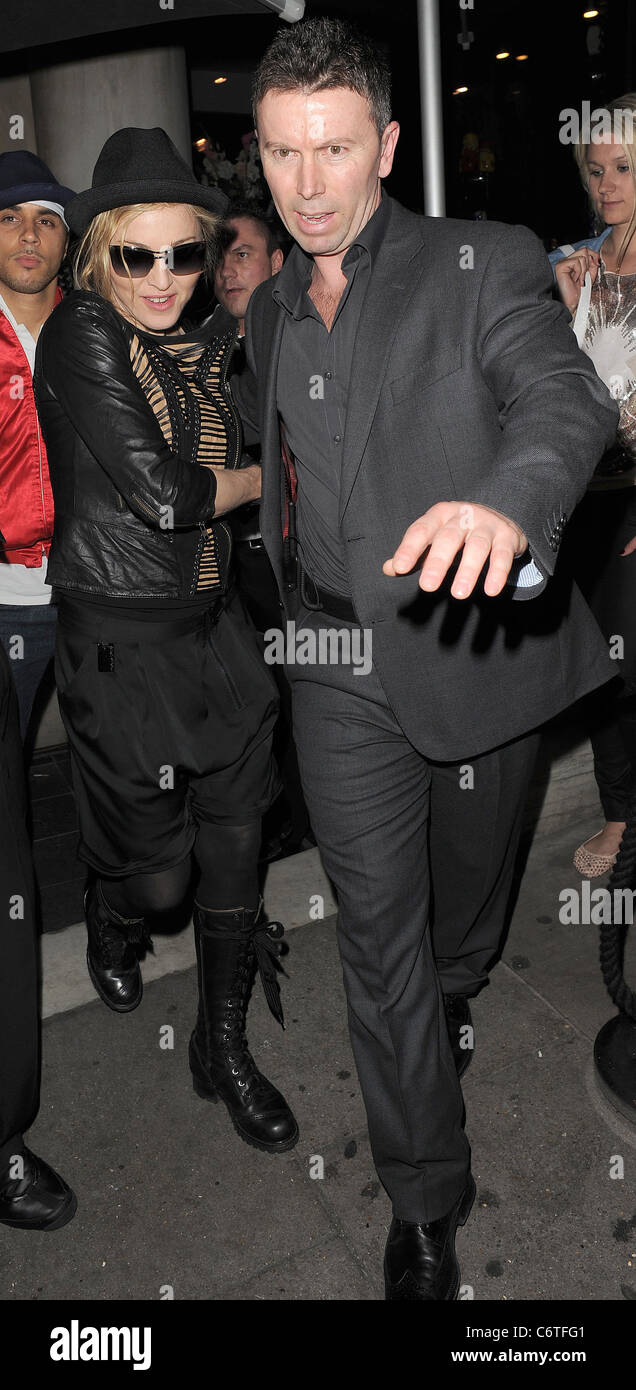Madonna is escorted out of Aura nightclub by her personal bodyguard ...