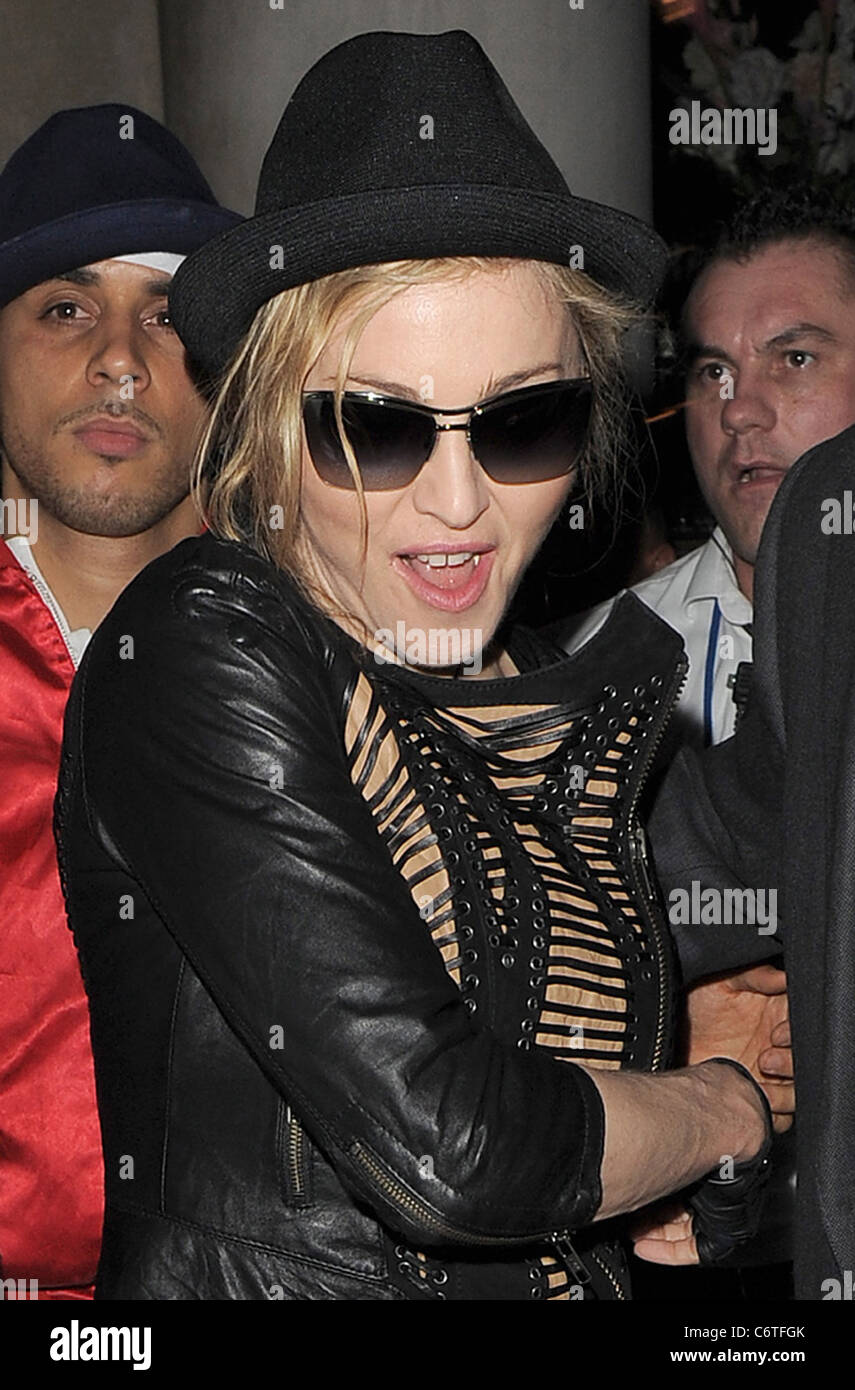Madonna is escorted out of Aura nightclub by her personal bodyguard ...