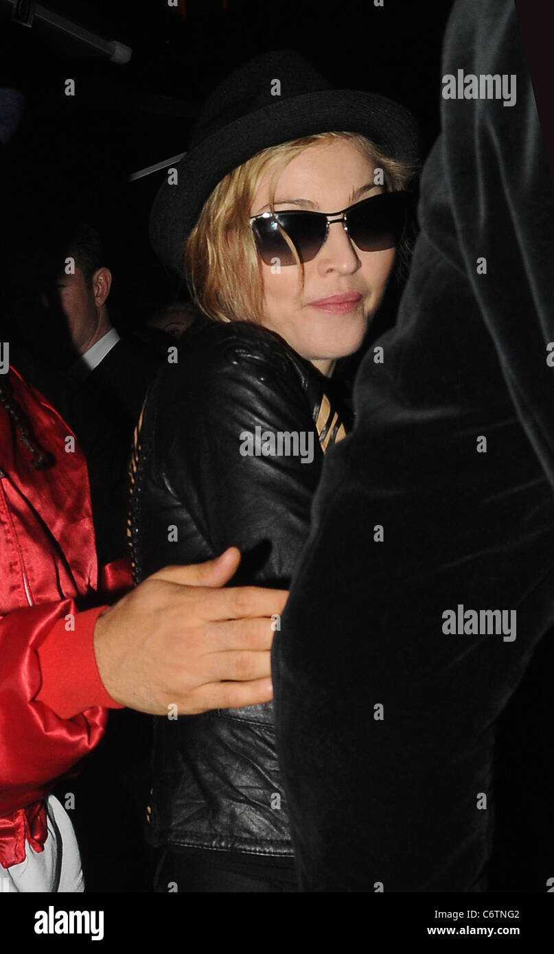 Madonna is escorted out of Aura night club by her personal bodyguard ...