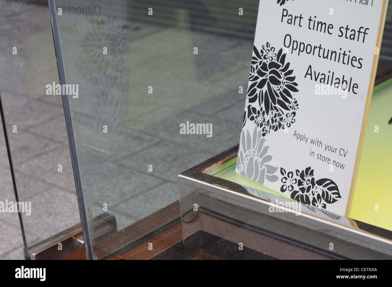 Staff vacancies help wanted sign in a shop window Stock Photo - Alamy