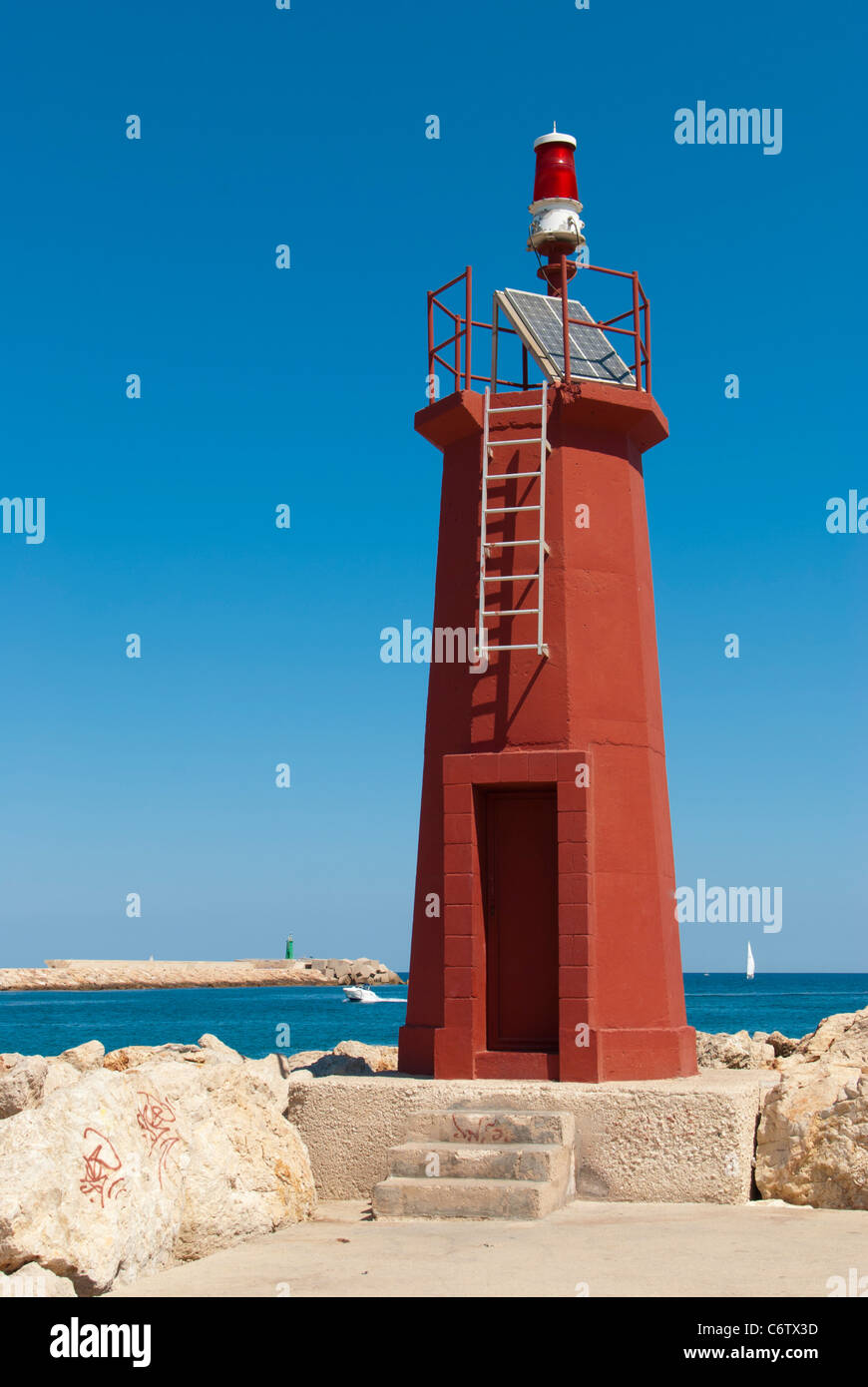 Small lighthouse/beacon at a harbor entrance, solar powered Stock Photo ...