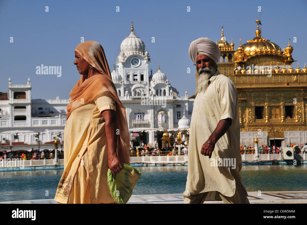 Pilgrims walking around Golden Temple by the holly lake Stock Photo - Alamy