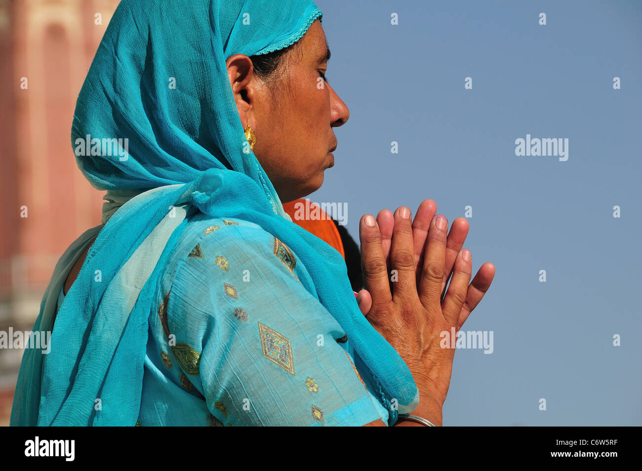 Sikh pilgrim woman praying for the God in Golden Temple Stock Photo - Alamy