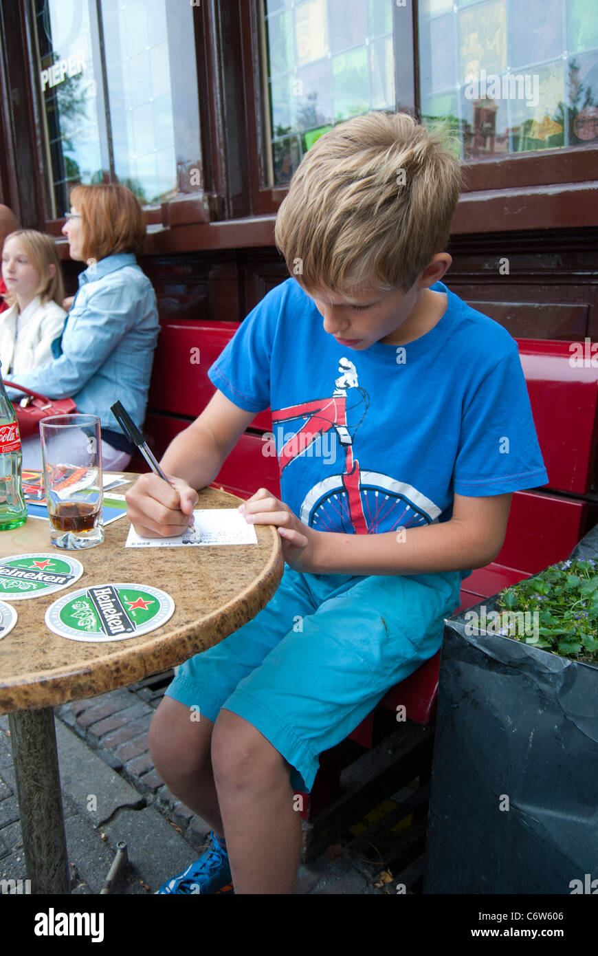 Boy writing postcards Stock Photo - Alamy