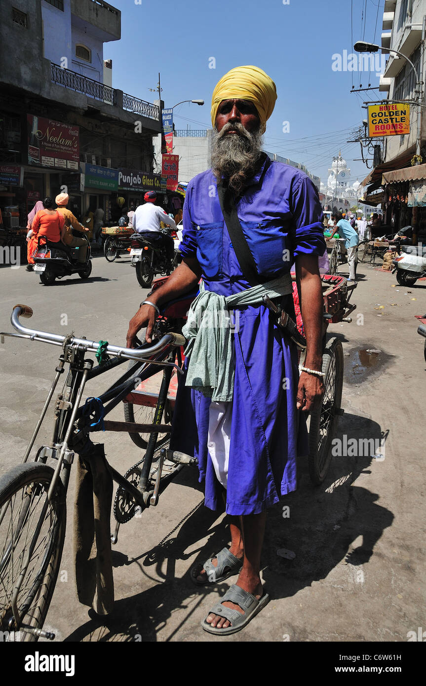 Rickshaw man in traditional Sikh style waiting customer on the street ...