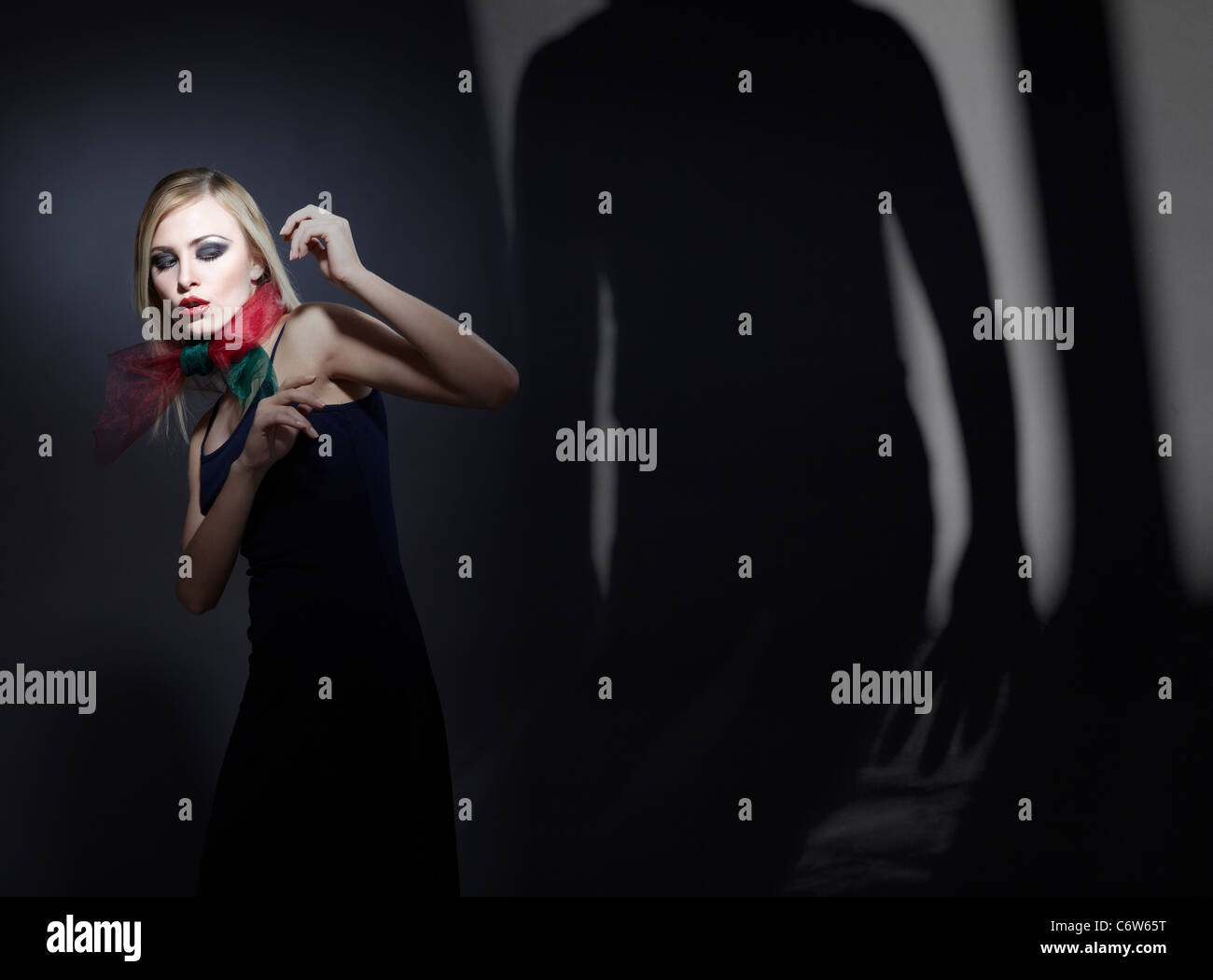 Woman in the dark interior with horror shadows Stock Photo - Alamy