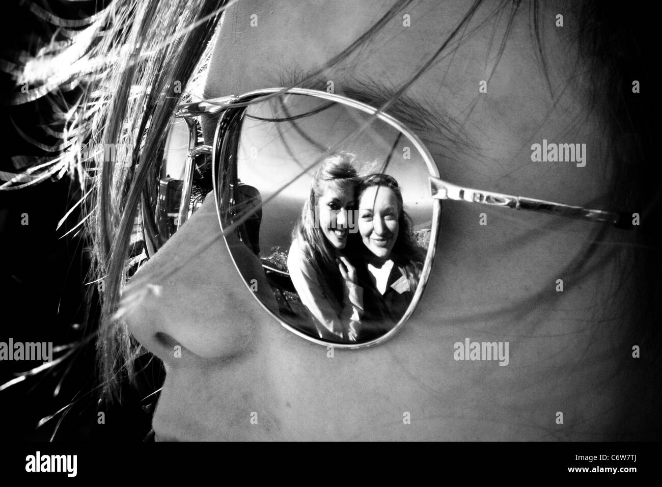 Reflection of two smiles in a pair of sunglasses Stock Photo - Alamy