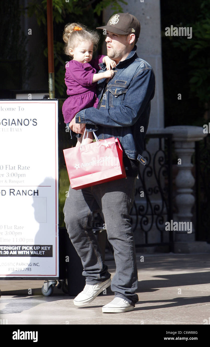 Joel Madden carries his daughter Harlow after shopping at the American ...