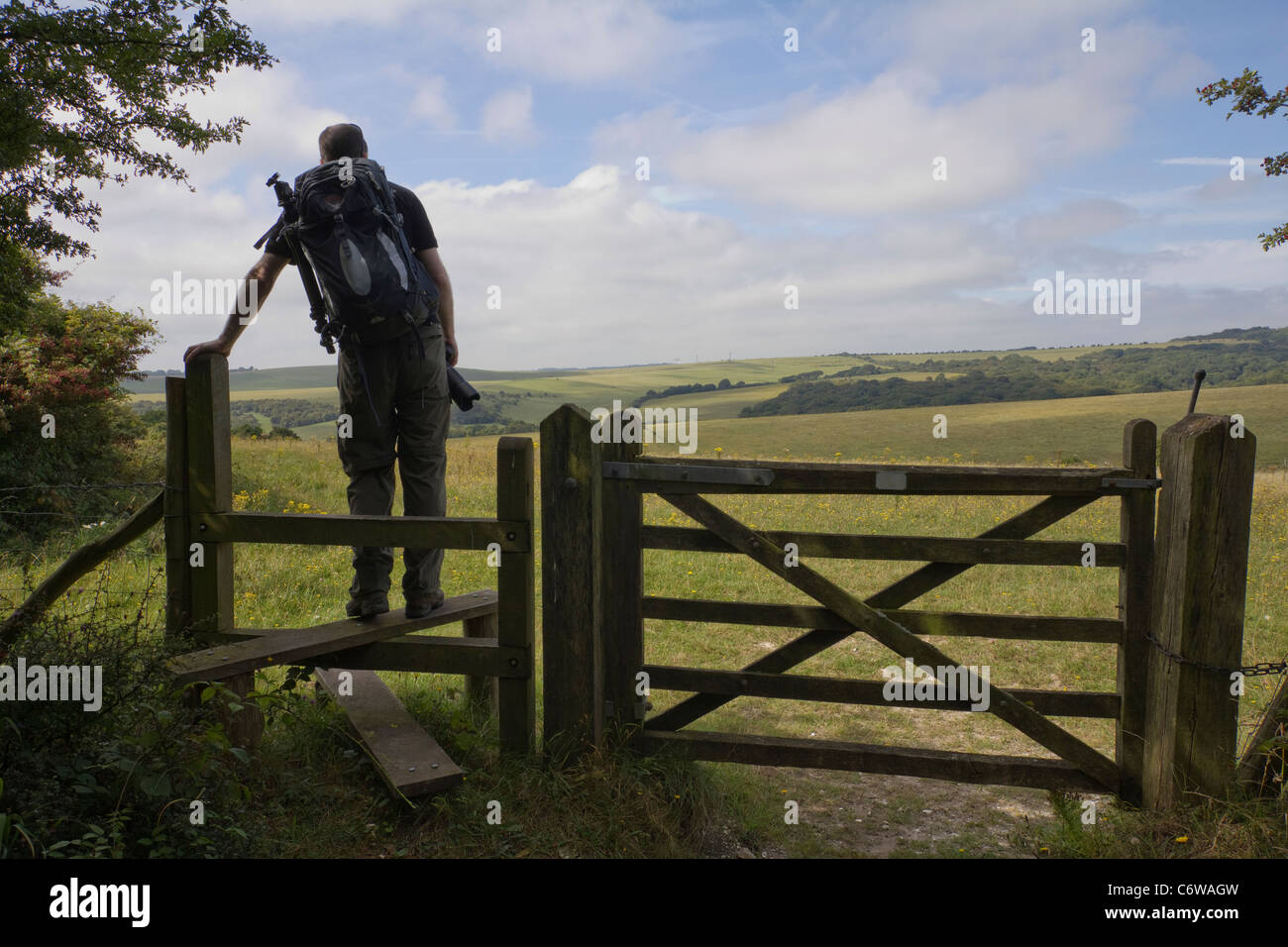 Tourist resting at stile South Downs East Sussex England UK Stock Photo ...