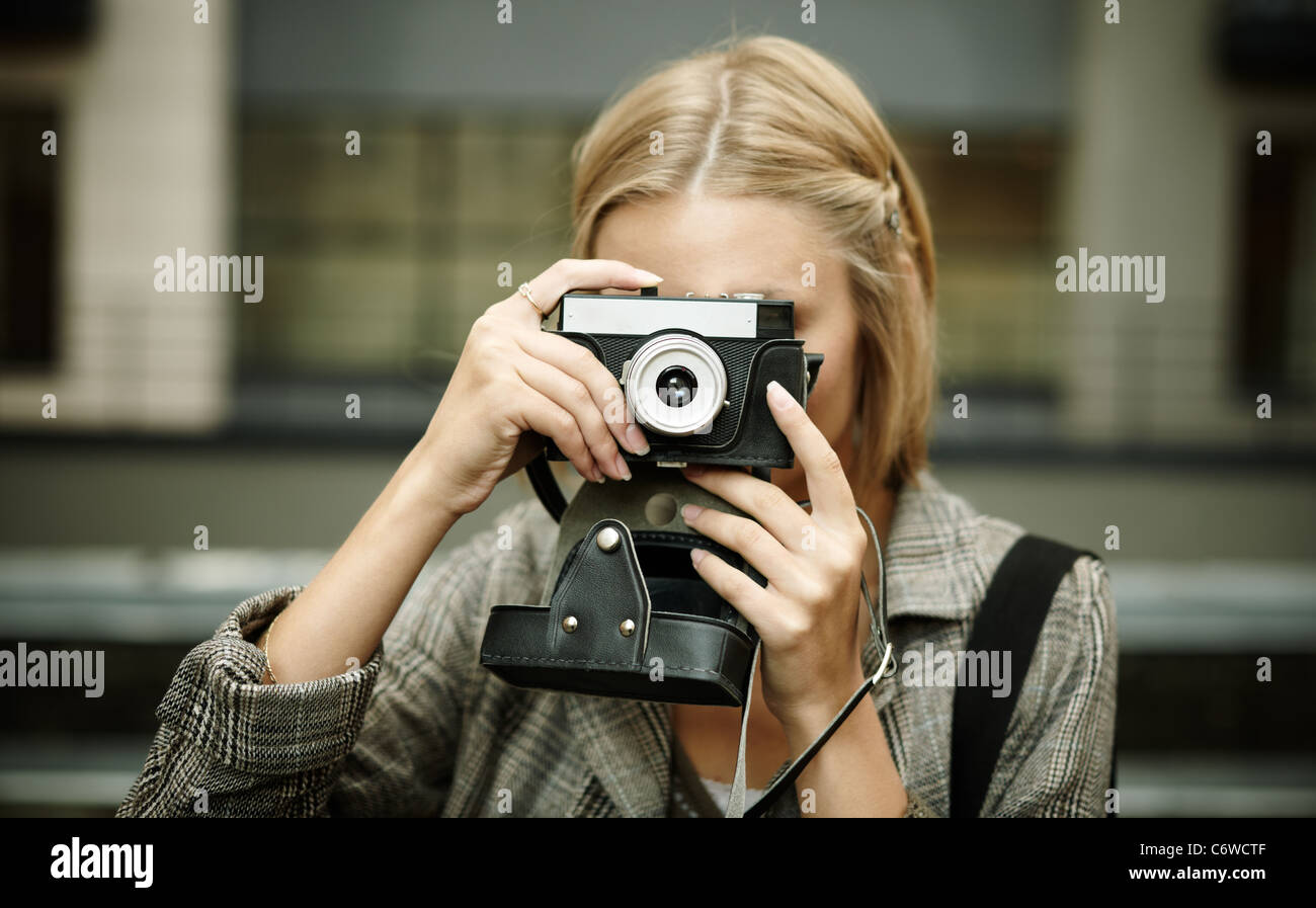 young woman with small camera on the street Stock Photo - Alamy