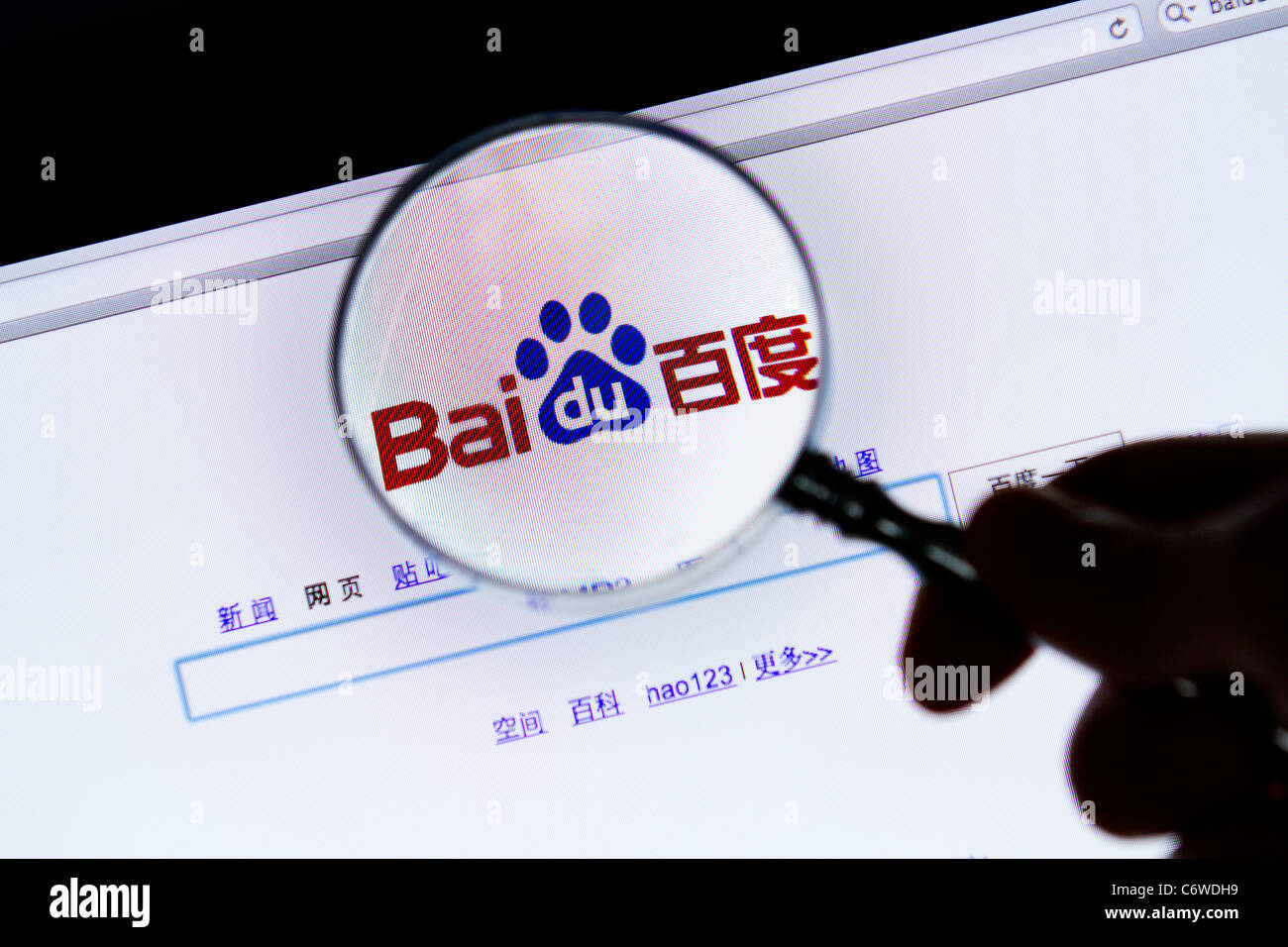 A magnifying glass being held over the Baidu homepage Stock Photo - Alamy