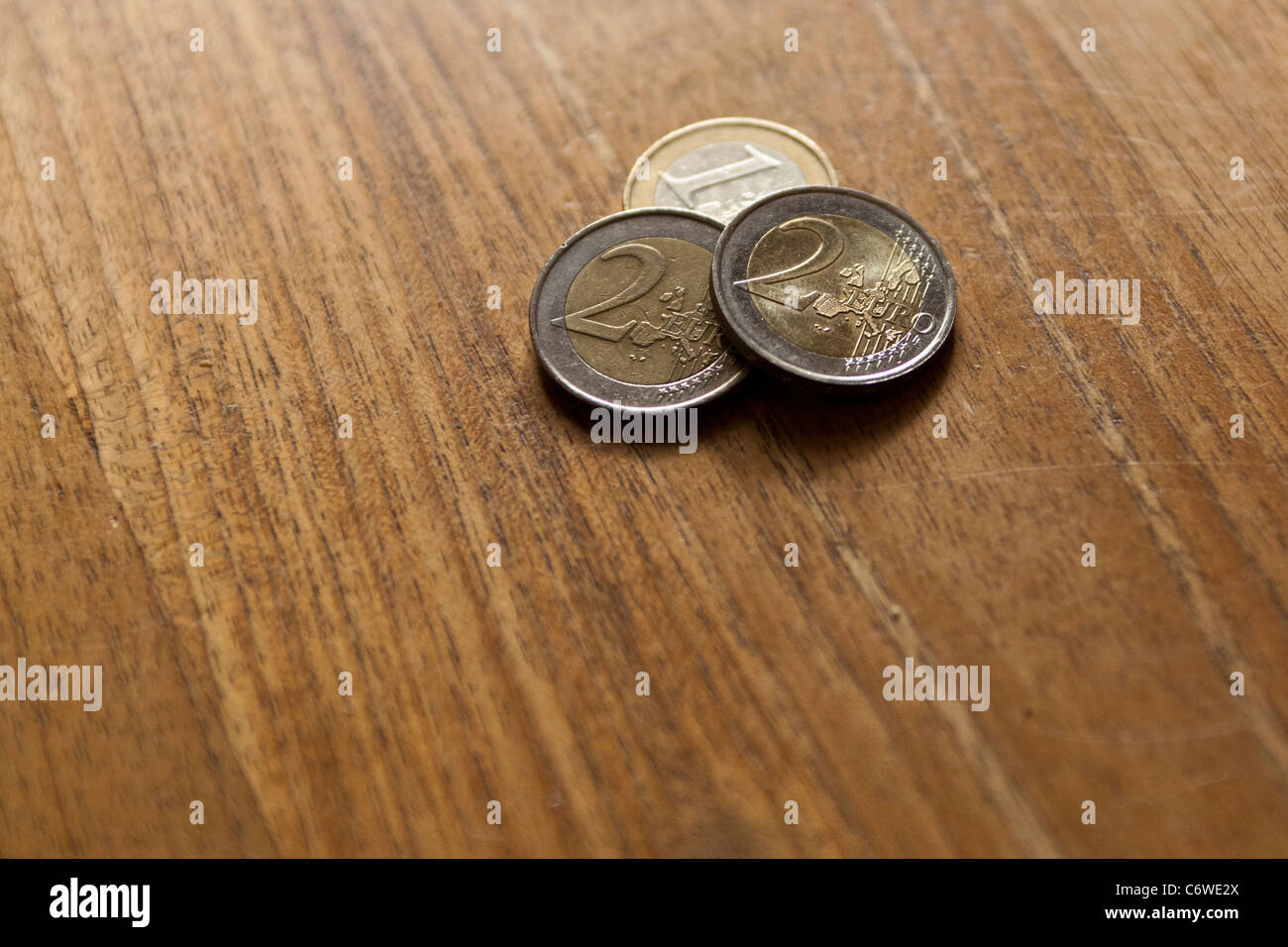 Euro coins on a table Stock Photo - Alamy