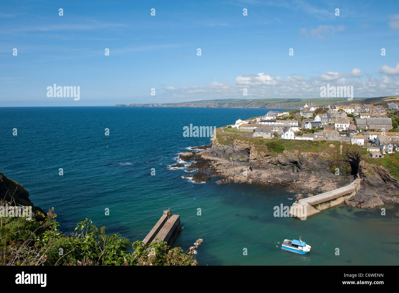 Small boat entering the pretty harbour of Port Issac in Cornwall ...