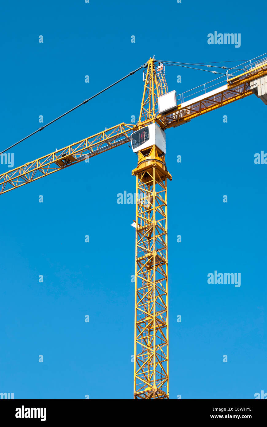 Yellow crane on blue sky background Stock Photo - Alamy