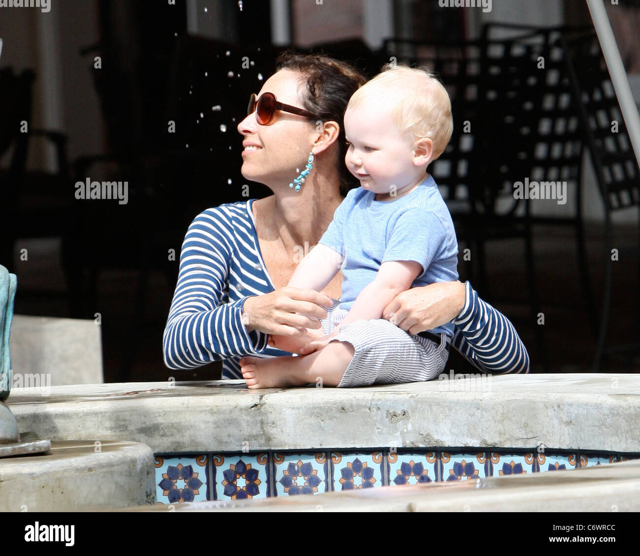 Minnie Driver and son Henry sitting by the wishing well at Cross Creek ...