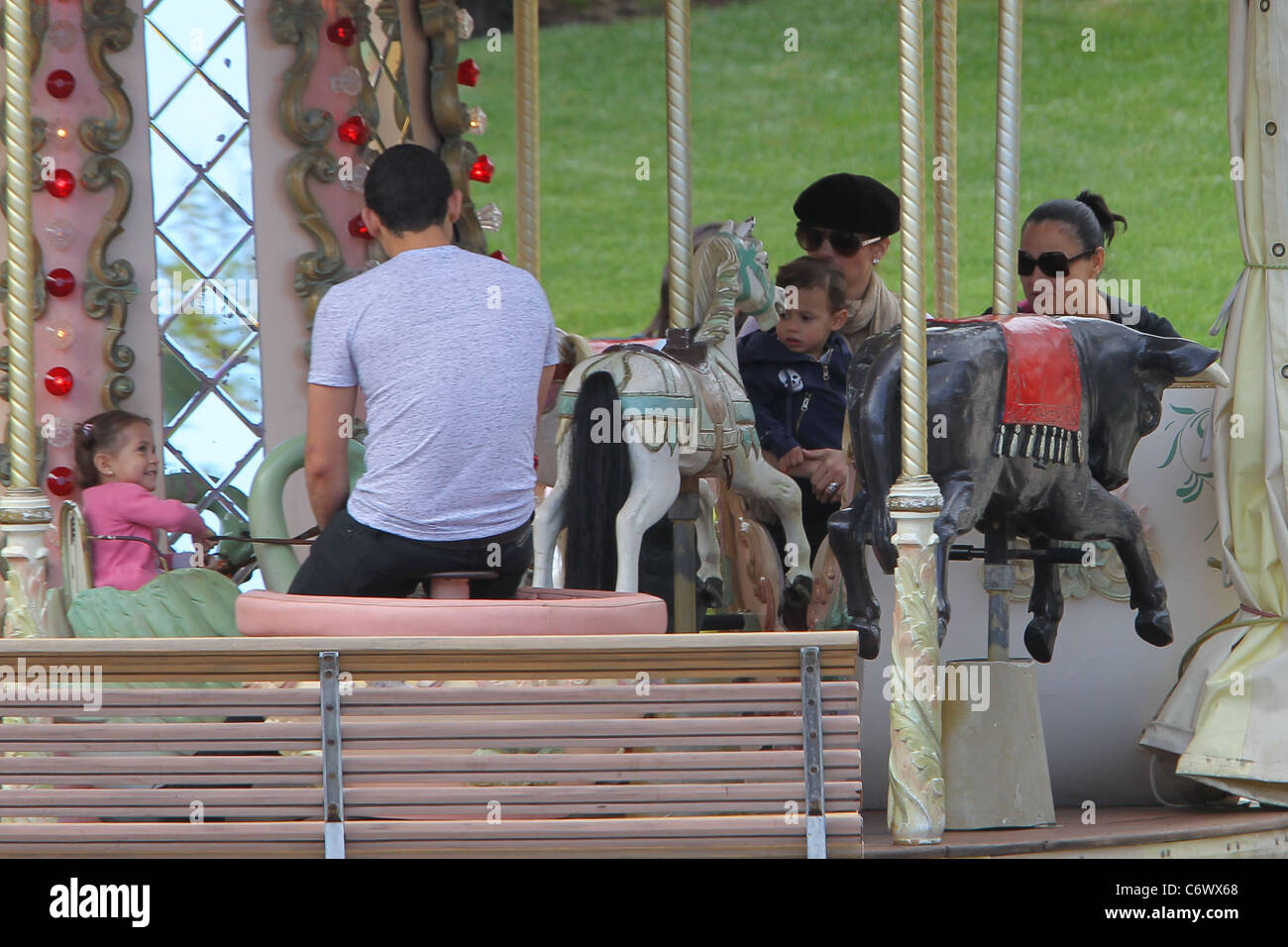 Jennifer Lopez with her twins Emma and Max enjoy a ride on the carousel ...