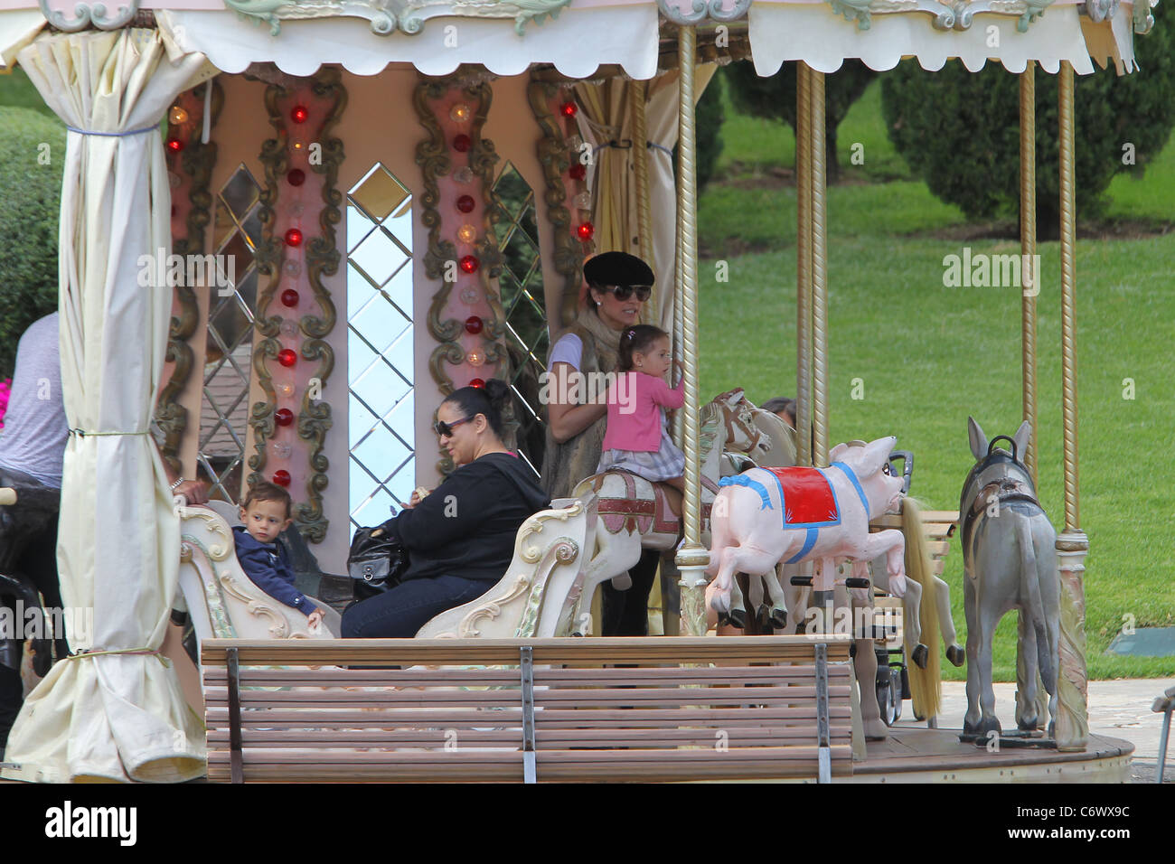 Jennifer Lopez with her twins Emma and Max enjoy a ride on the carousel ...