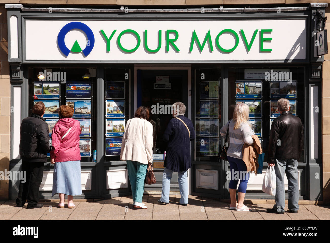 People viewing property in the window of the Your Move estate agency ...
