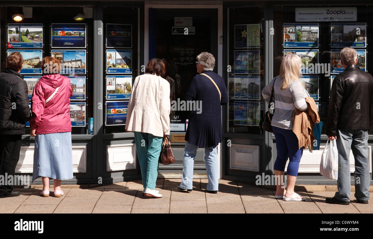 People viewing property in the window of the Your Move estate agency ...