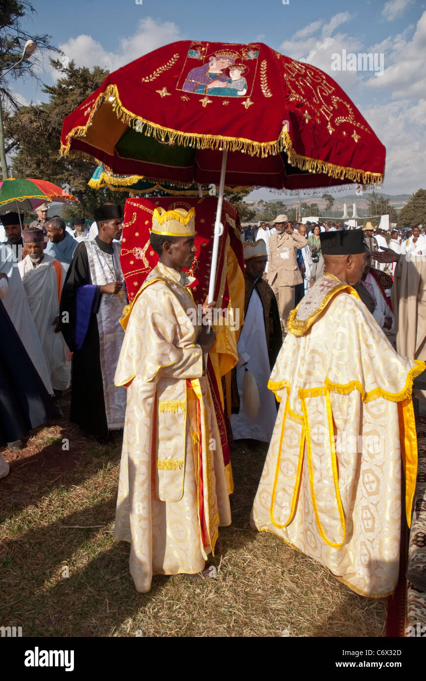 Christian Orthodox devotees walking under their ceremonial umbrella at ...