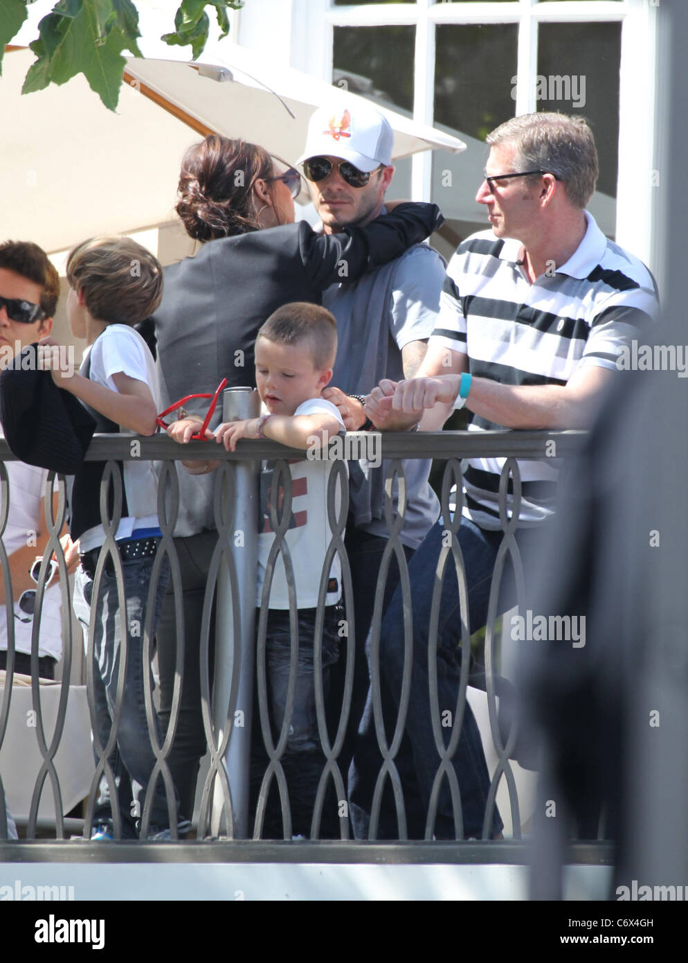 David Beckham and Victoria Beckham hug each other while their sons Cruz ...