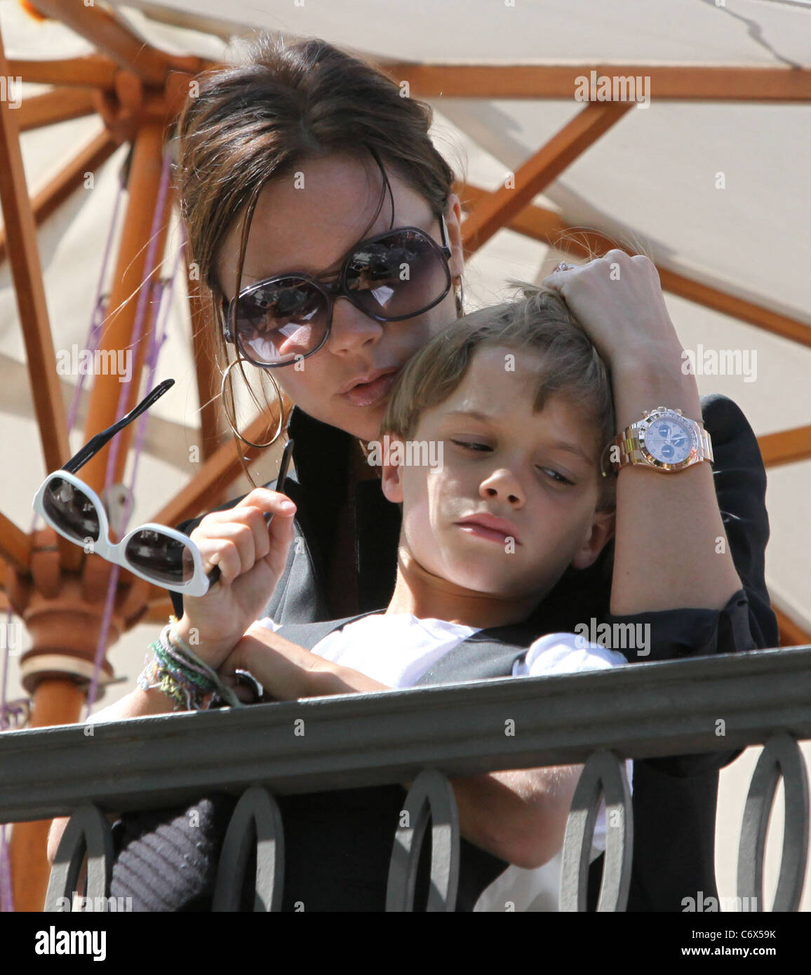 Victoria Beckham and her son Romeo watch the Jonas Brothers perform ...