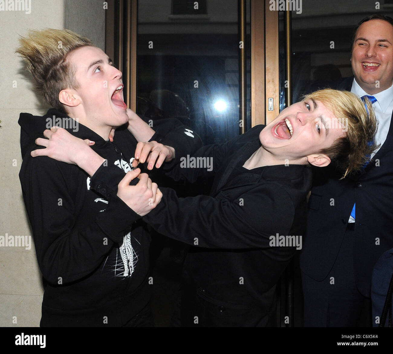 John and Edward Grimes, aka Jedward, pose for pictures with fans ...