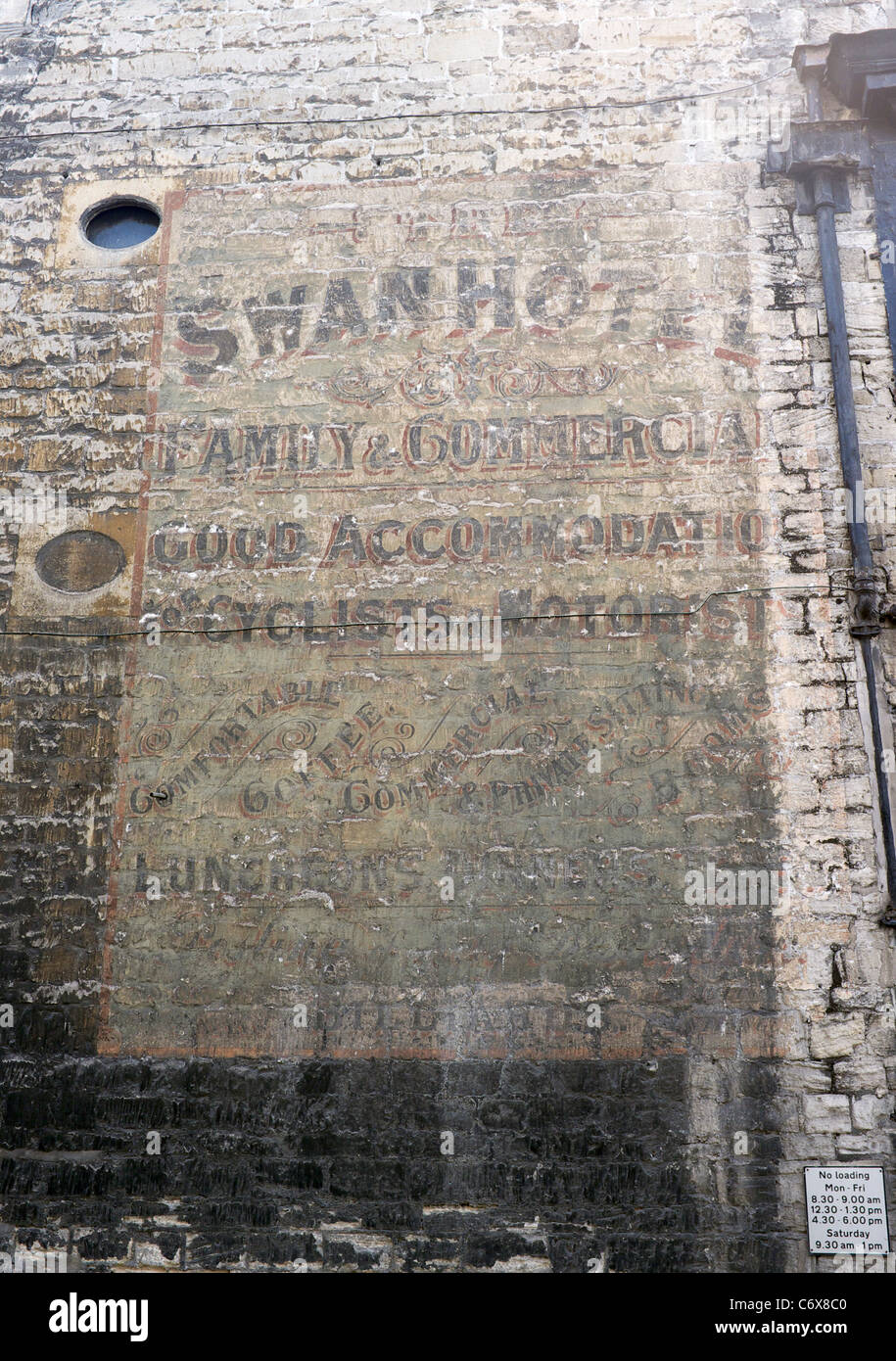 Fading old hand painted advertisement on the side of a building in ...