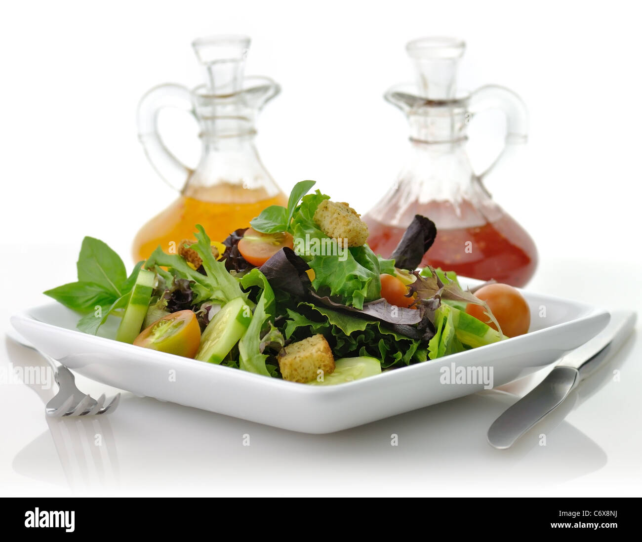 a fresh vegetable salad in a white dish with salad dressing Stock Photo ...