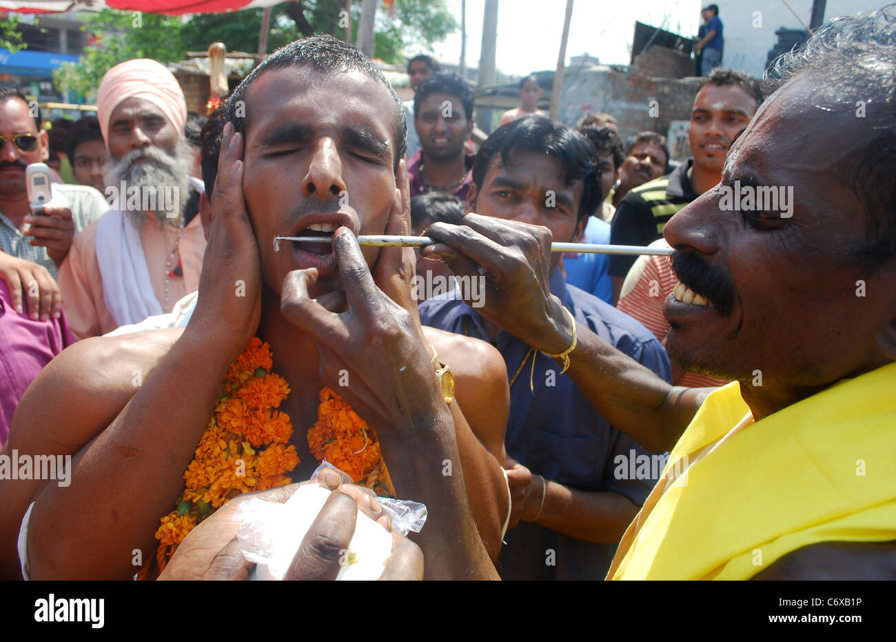 A religious devotee in Amritsar, India has a spike pierced through his ...