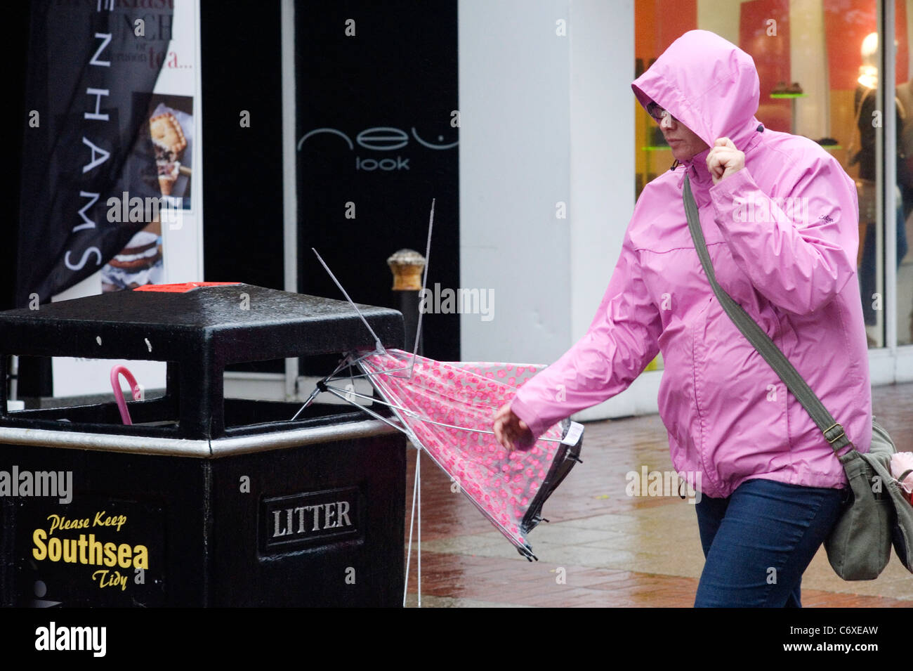 Woman walking past shops hi-res stock photography and images - Alamy