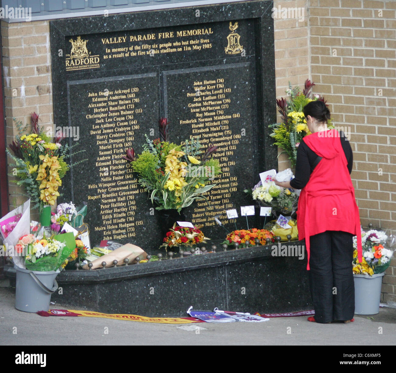 People visit the memorial for the victims of the Bradford City stadium ...