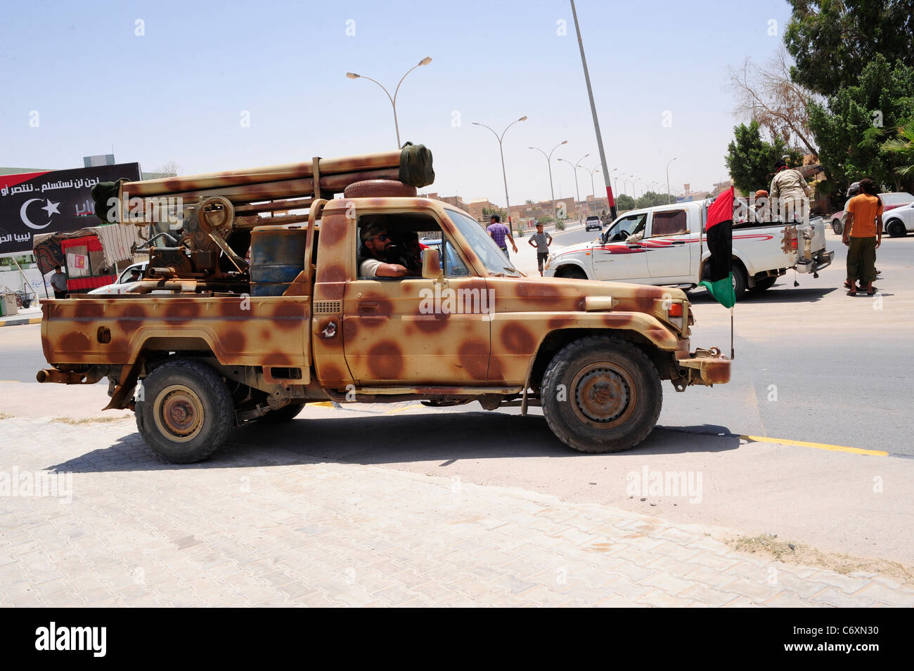 A pick up truck with a home made 120mm gun on the back heading to the ...