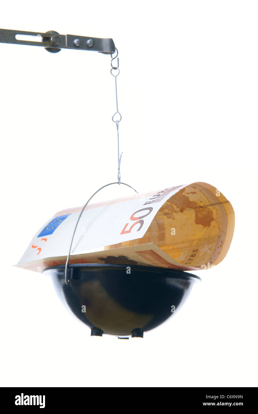 scale pan with money Stock Photo - Alamy