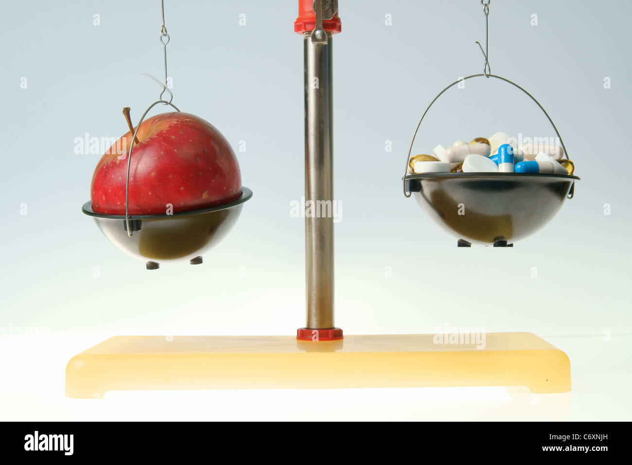 Red apple food supplements in pills - balance Stock Photo - Alamy