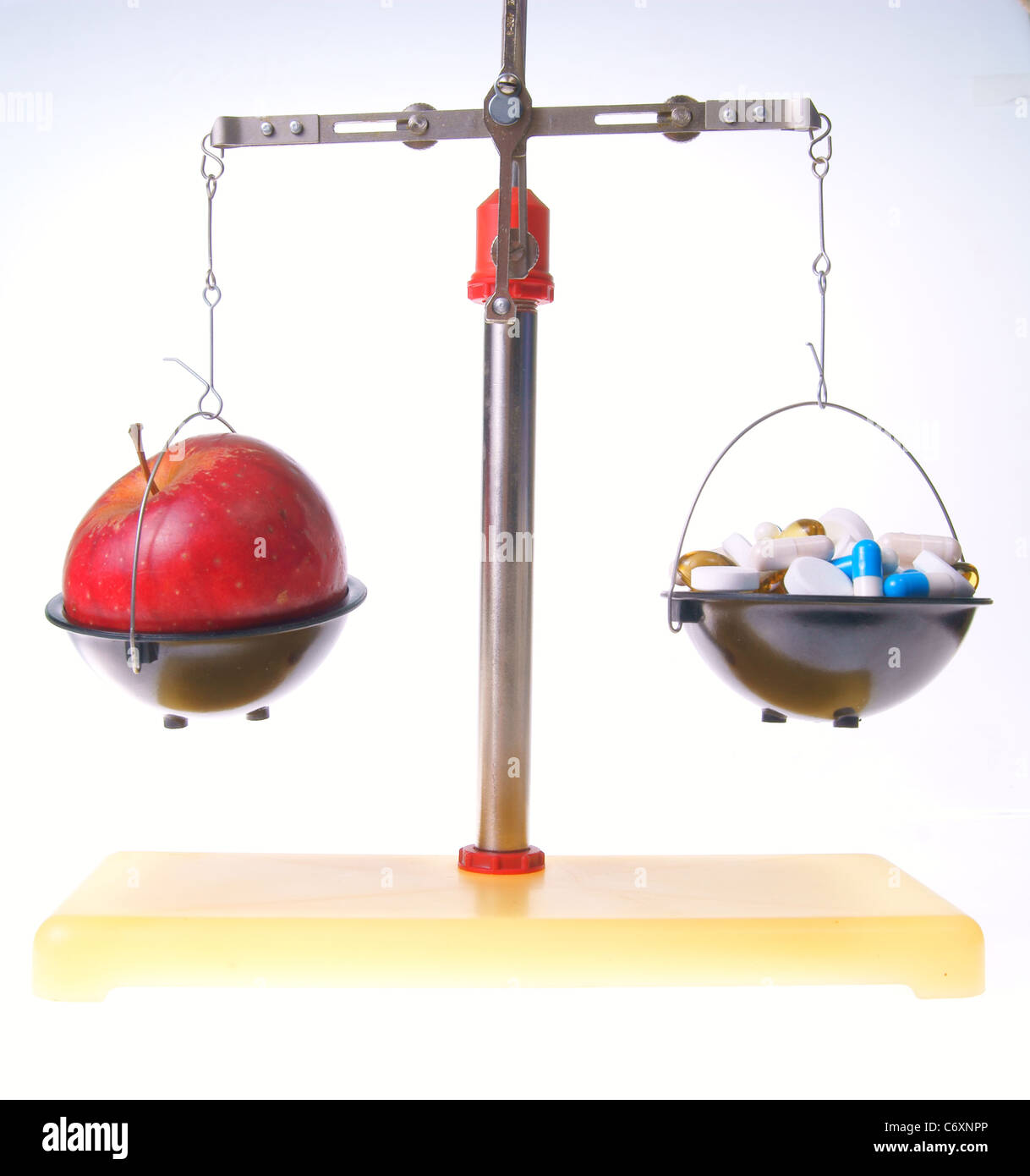 Red apple food supplements in pills - balance Stock Photo - Alamy