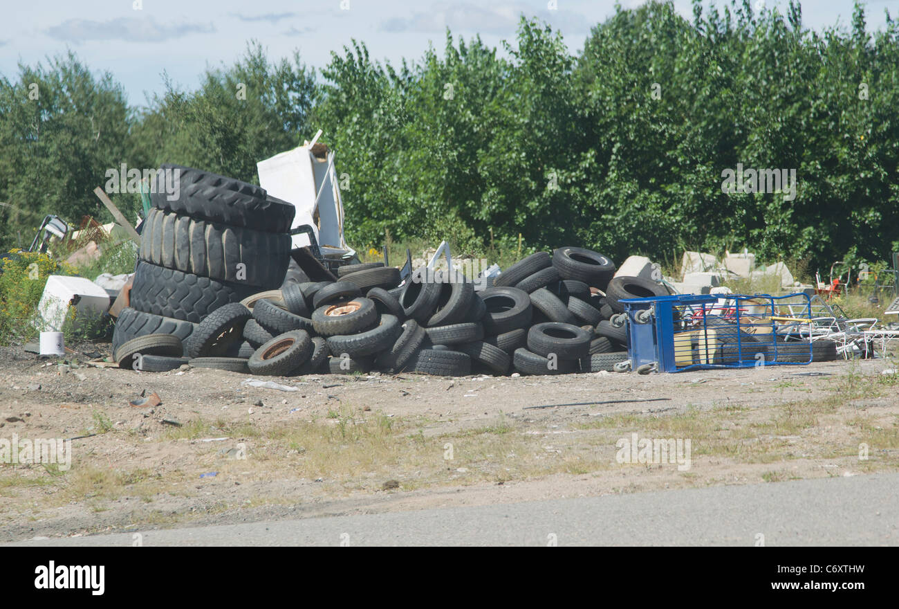 A big stack of old car and tractor tires waiting to be recycled at the ...
