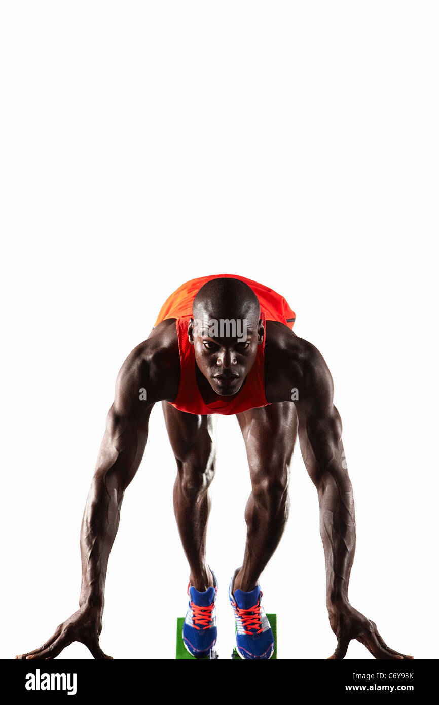 Runner crouched at starting line Stock Photo - Alamy