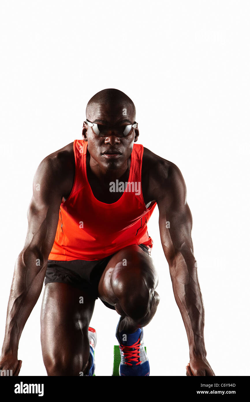 Runner crouched at starting line Stock Photo - Alamy