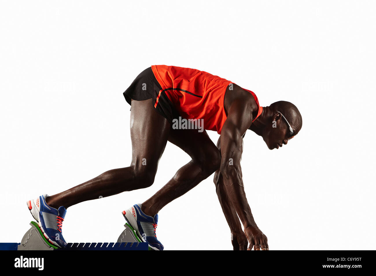 Runner crouched at starting line Stock Photo - Alamy