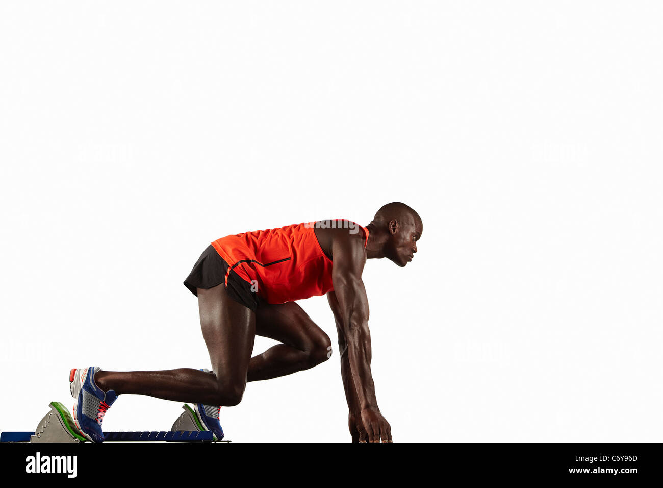 Runner crouched at starting line Stock Photo - Alamy