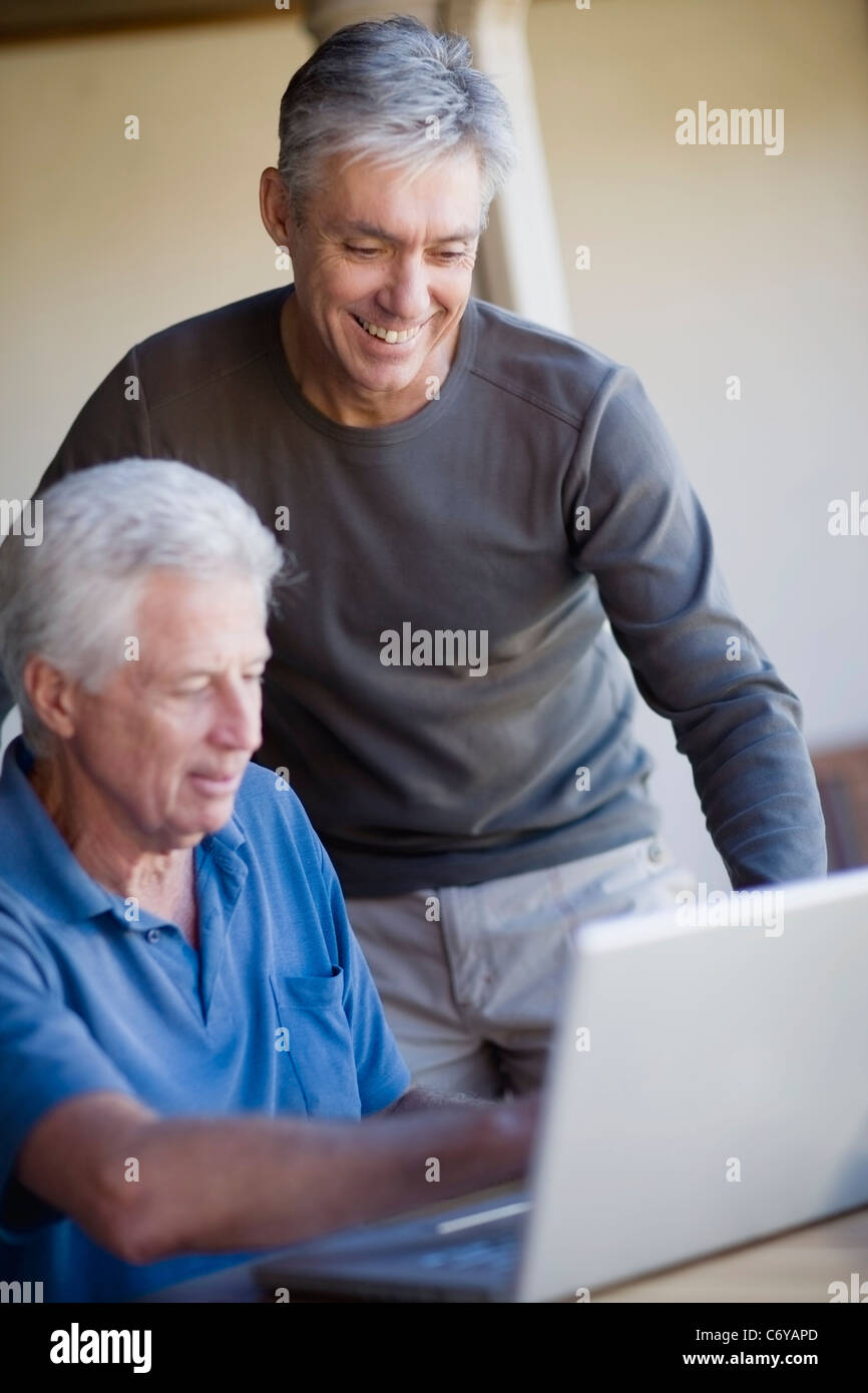 Older men using laptop together Stock Photo - Alamy