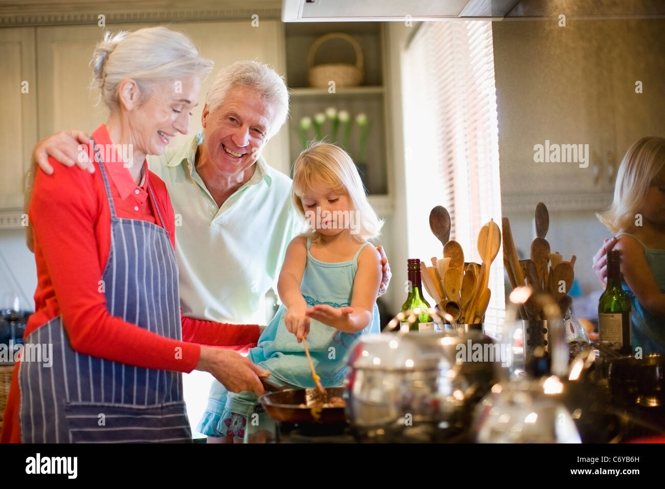 Family cooking together in kitchen Stock Photo - Alamy
