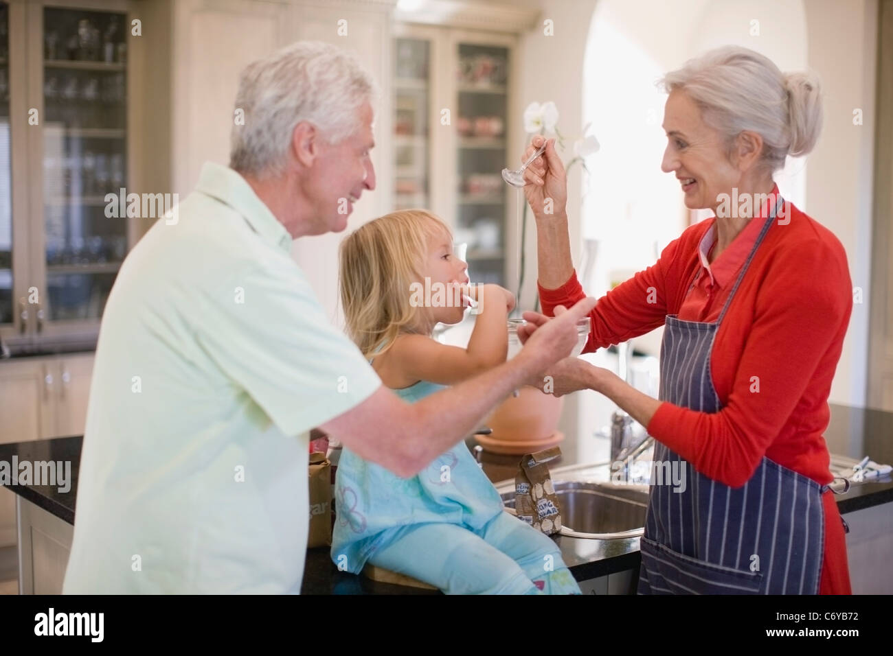 Family cooking together in kitchen Stock Photo - Alamy