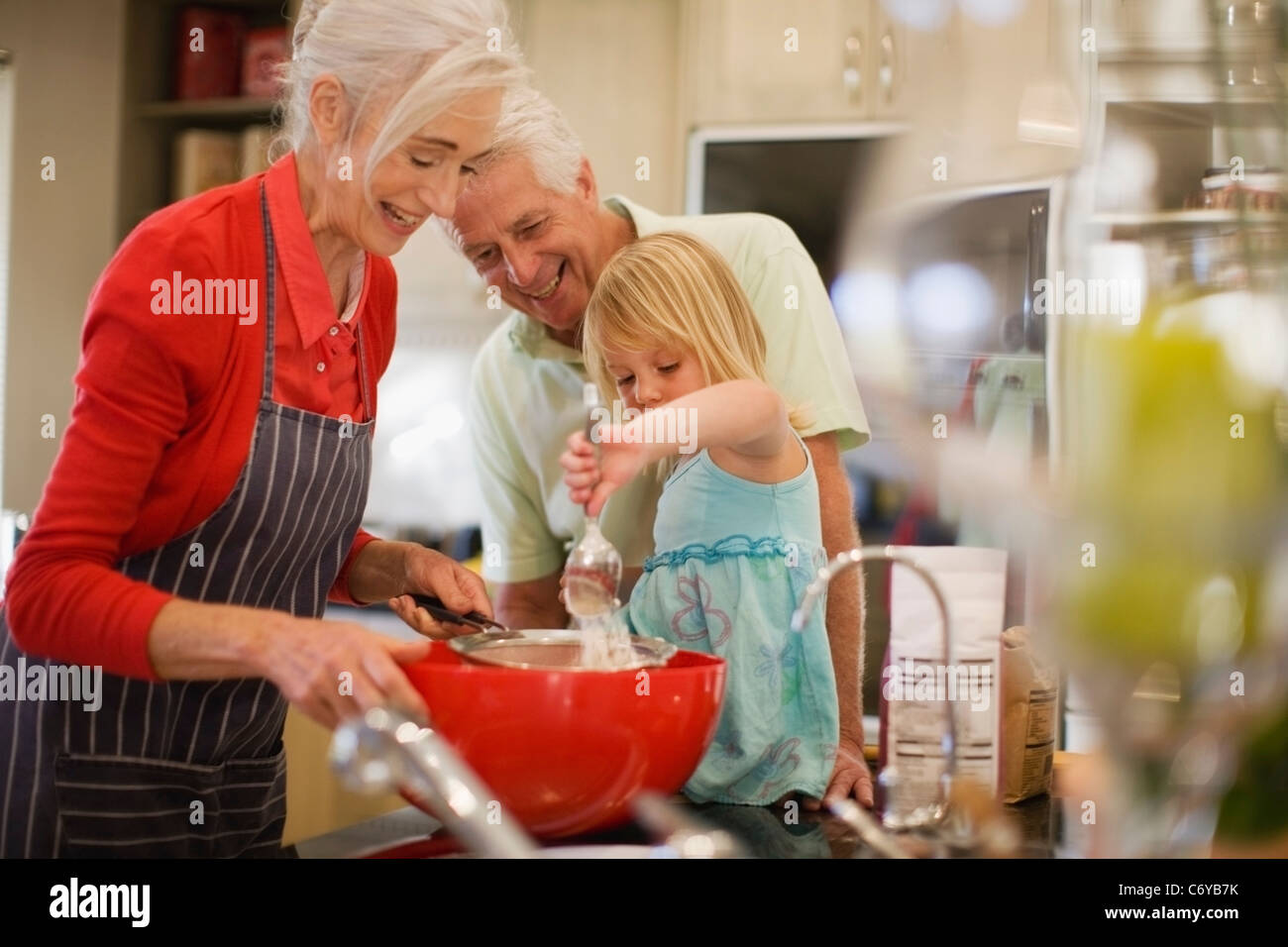 Family cooking together in kitchen Stock Photo - Alamy