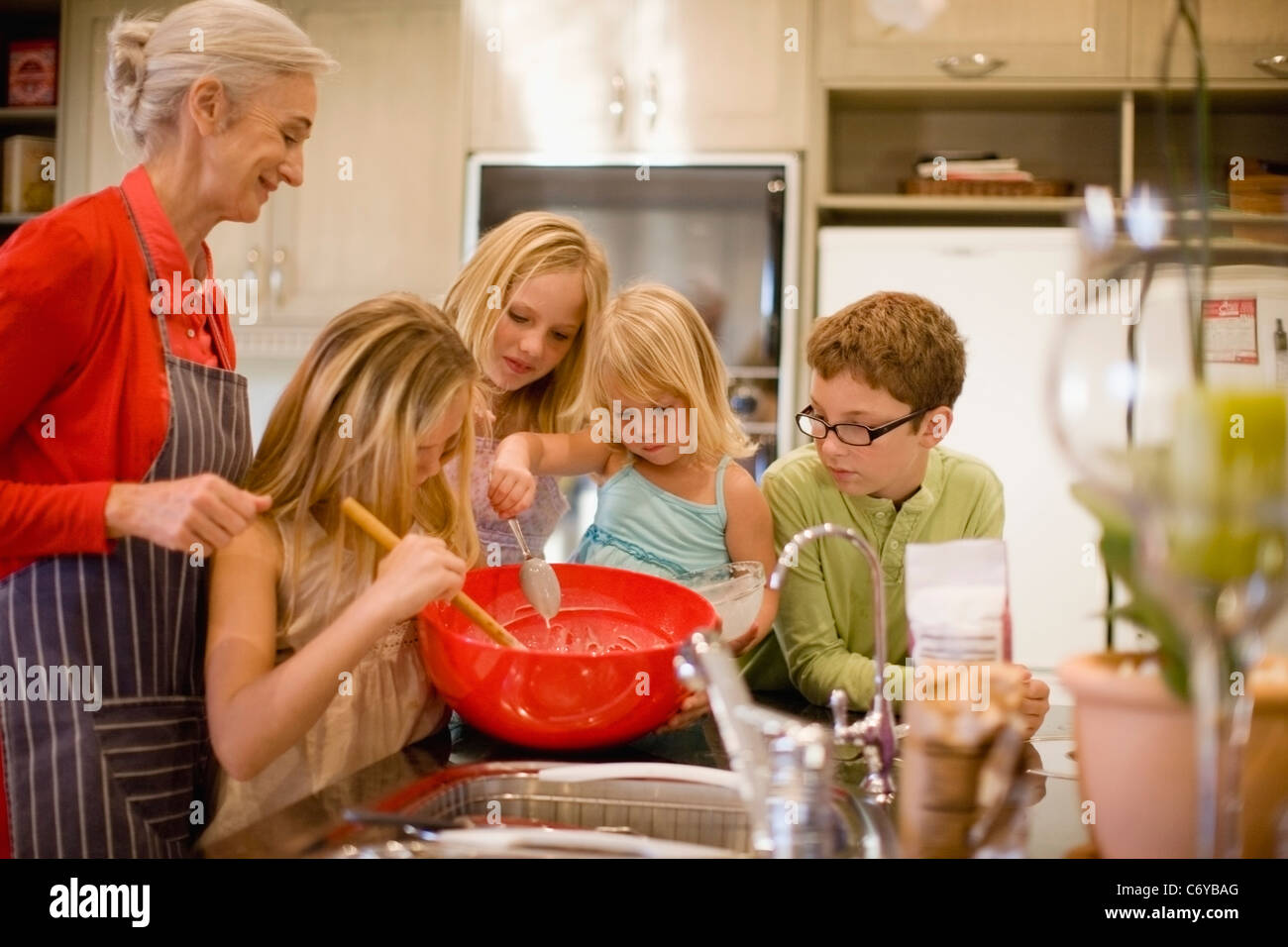 Family cooking together in kitchen Stock Photo - Alamy